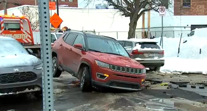 Vehicle gets stuck in a sinkhole from a water main break in the Strip ...